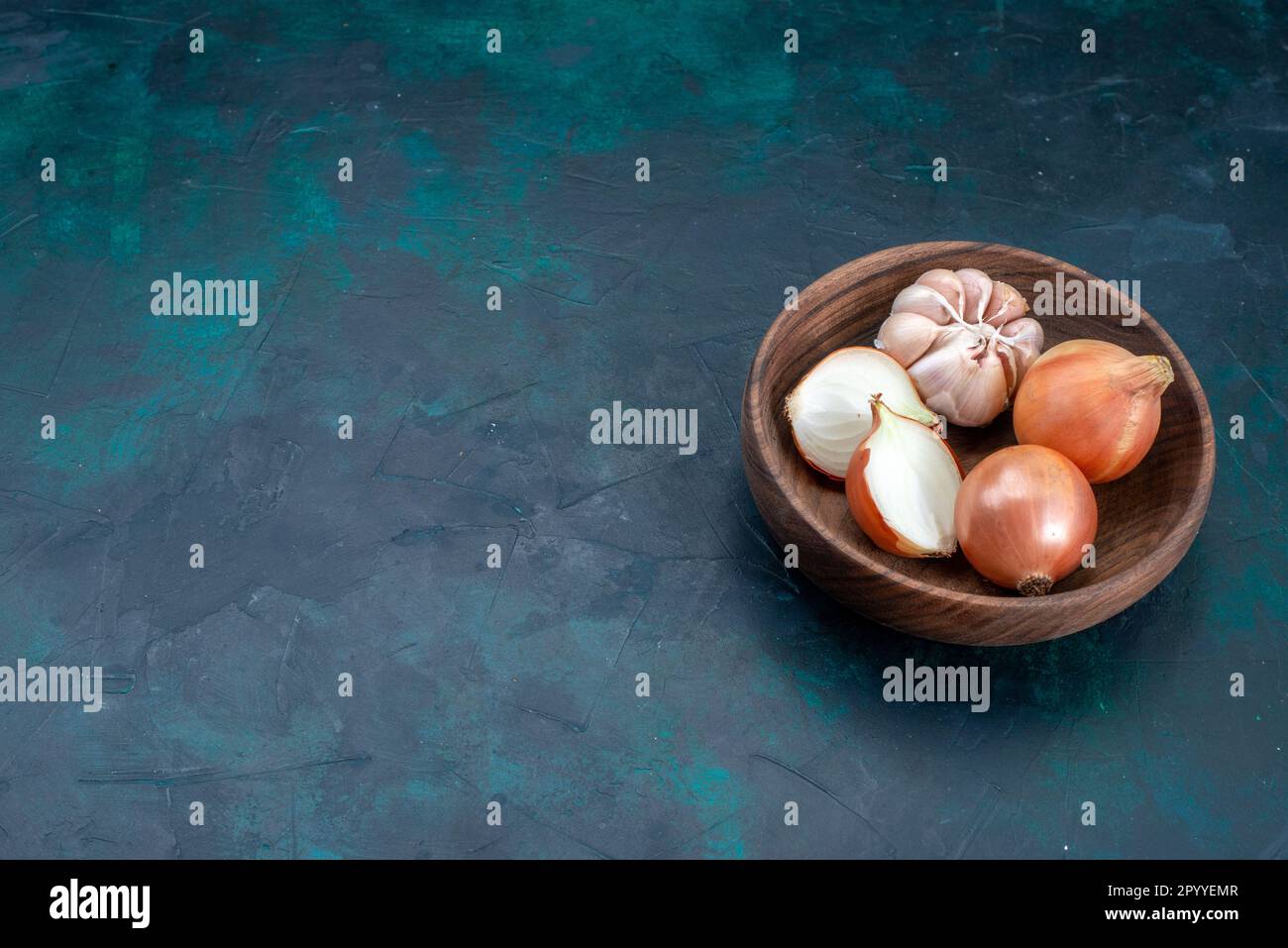 front view onions and garlic on dark-blue desk vegetable meal food ...