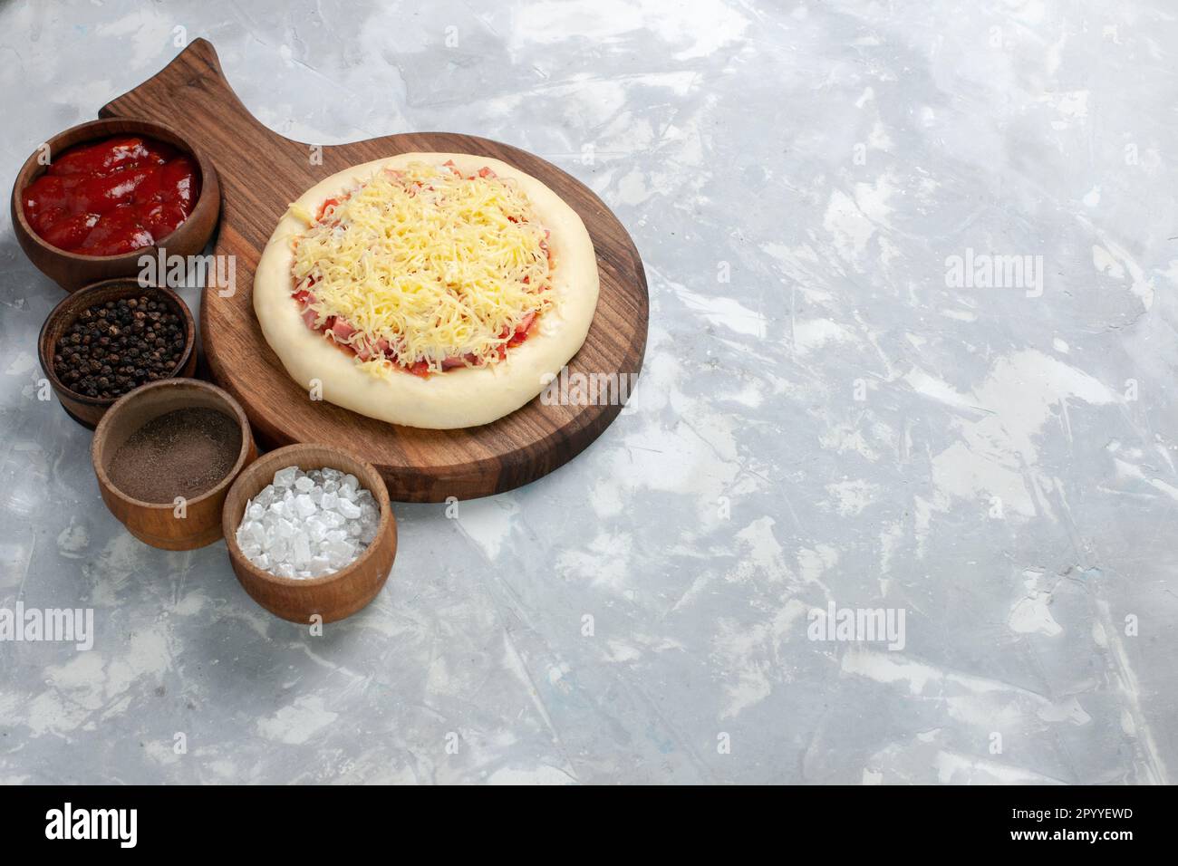 front view raw pizza with different seasonings on white desk meal food ...