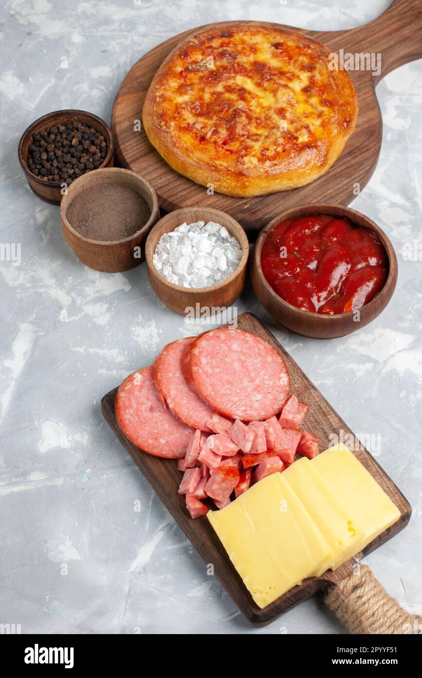 top view baked pizza sliced with cheese on a white background meal food ...
