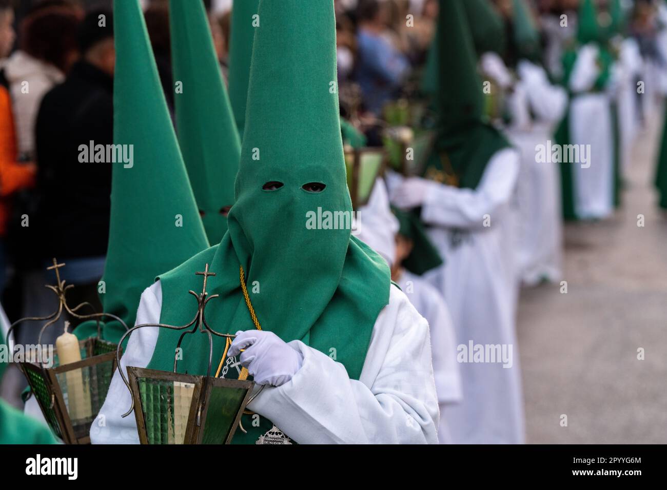 Cofradias wearing green cone shaped hats lead a procession during Holy ...