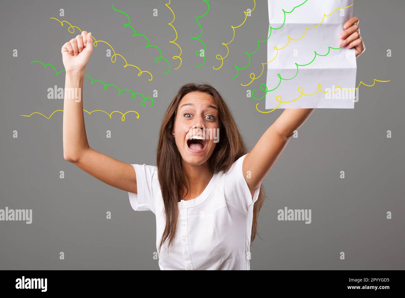 Young woman elated and happy over the written contents of the paper she ...