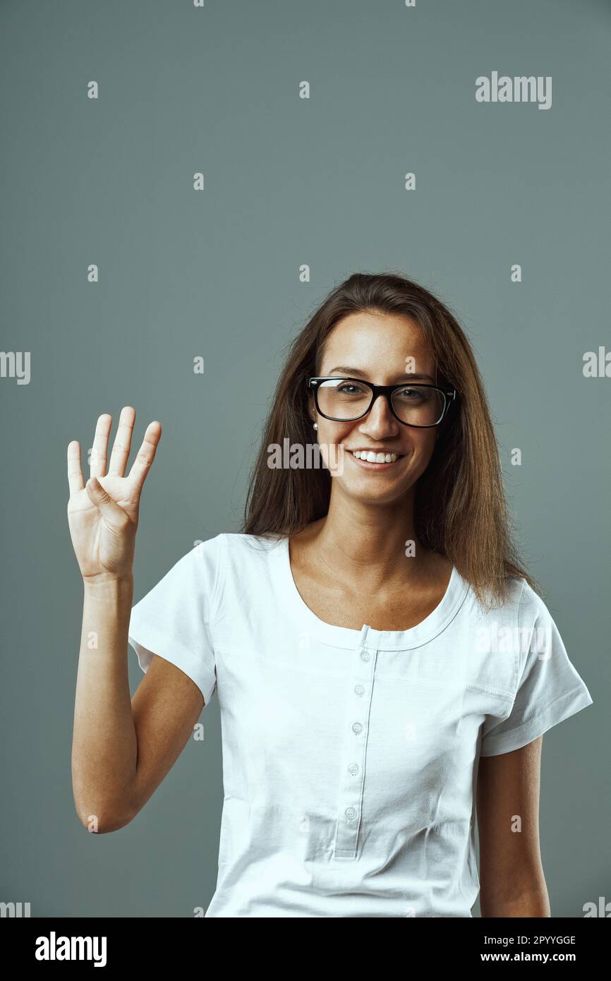 Young woman, glasses, white shirt, frontal portrait, raising hand, four ...