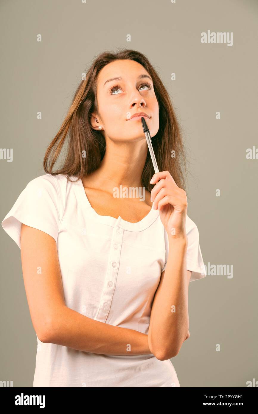 Portrait of a young woman thinking and having great ideas, inventing ...