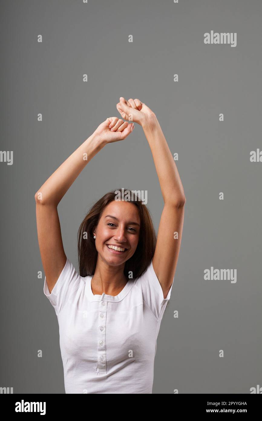 Dance or great joy and frenzy with raised arms. Emotional portrait of a ...