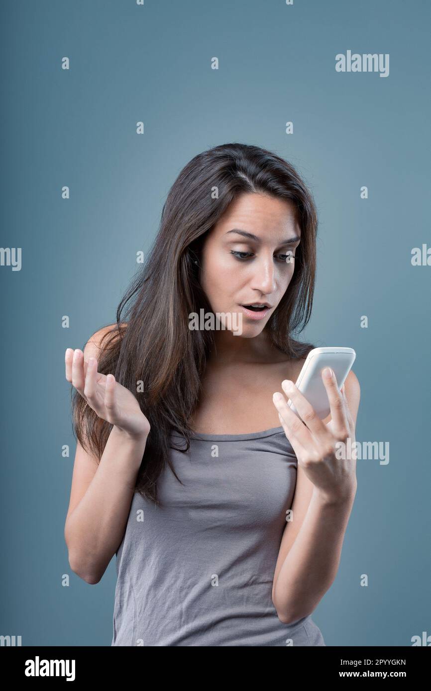 Emotional portrait of a young woman isolated on a neutral background ...