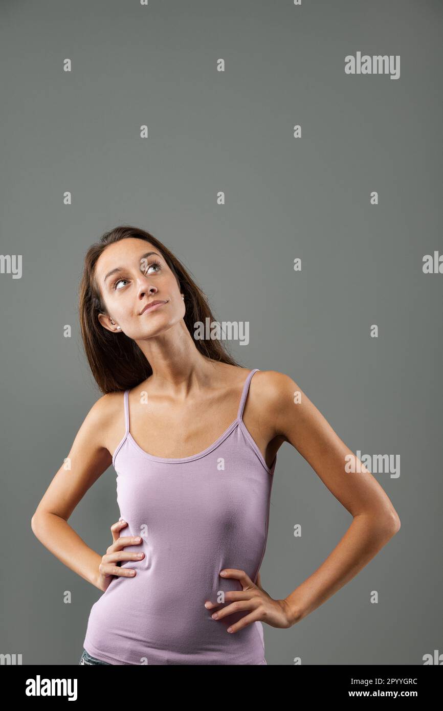 Emotional portrait of young woman isolated on neutral background. Looks ...