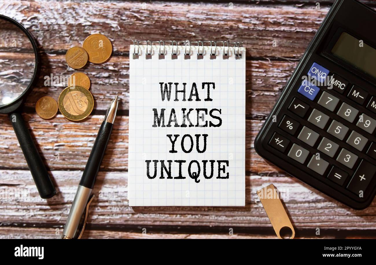 What makes you unique text and alarm clock on white brick wall and ...