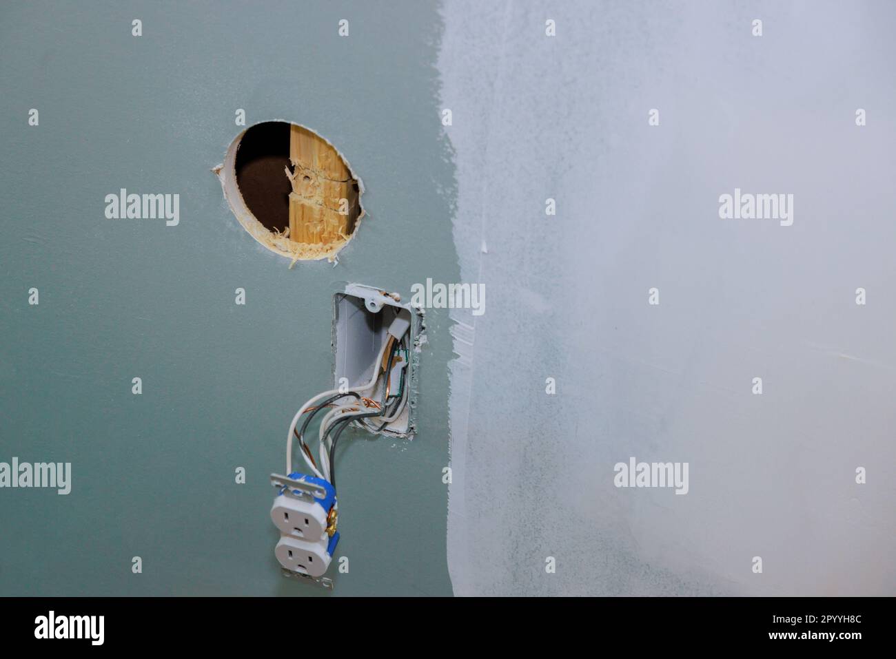 Installation of new current socket by an electrician working in ...