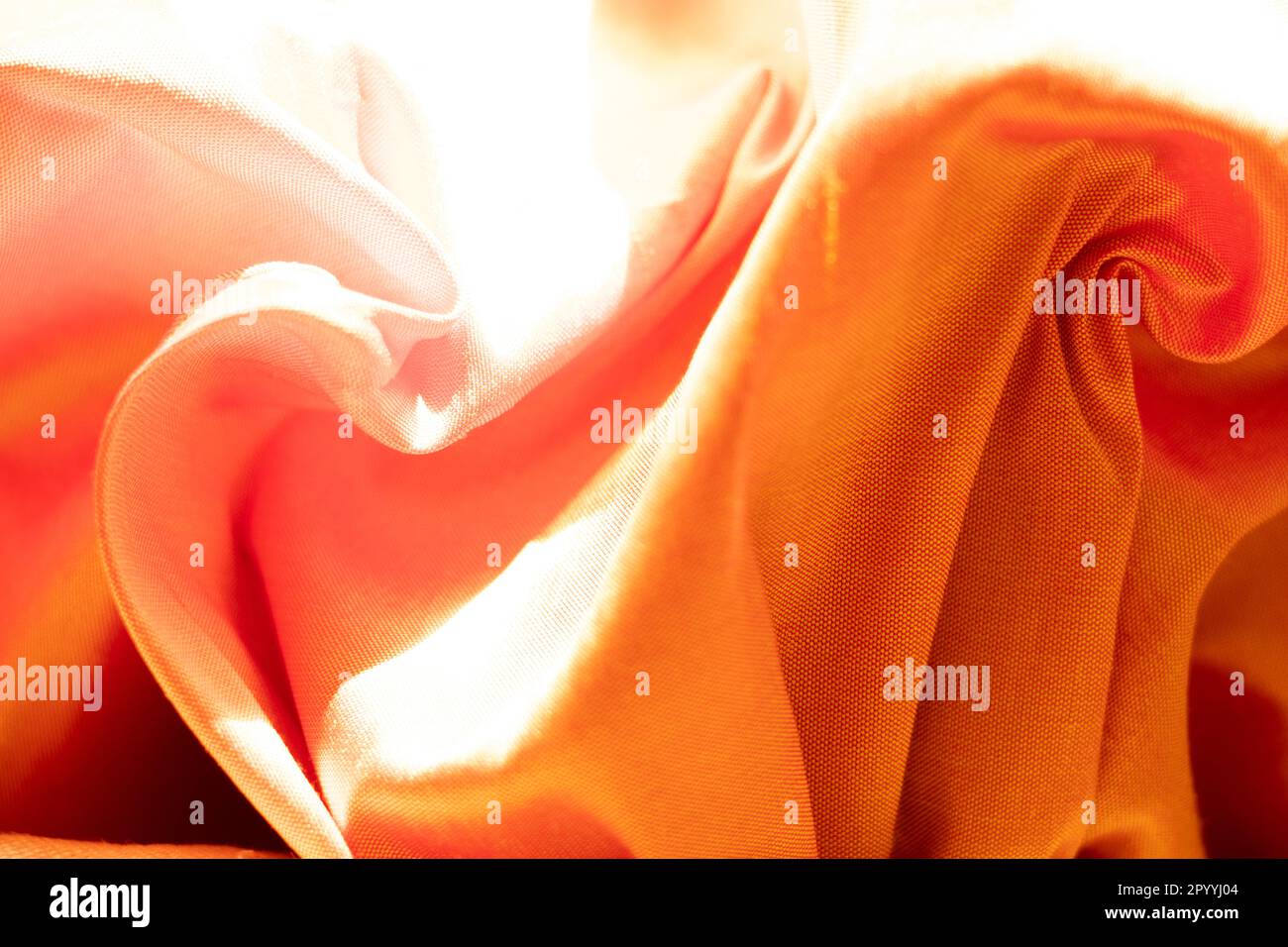 Golden wavy fabric in the sun as a background, golden fabric, wallpaper ...