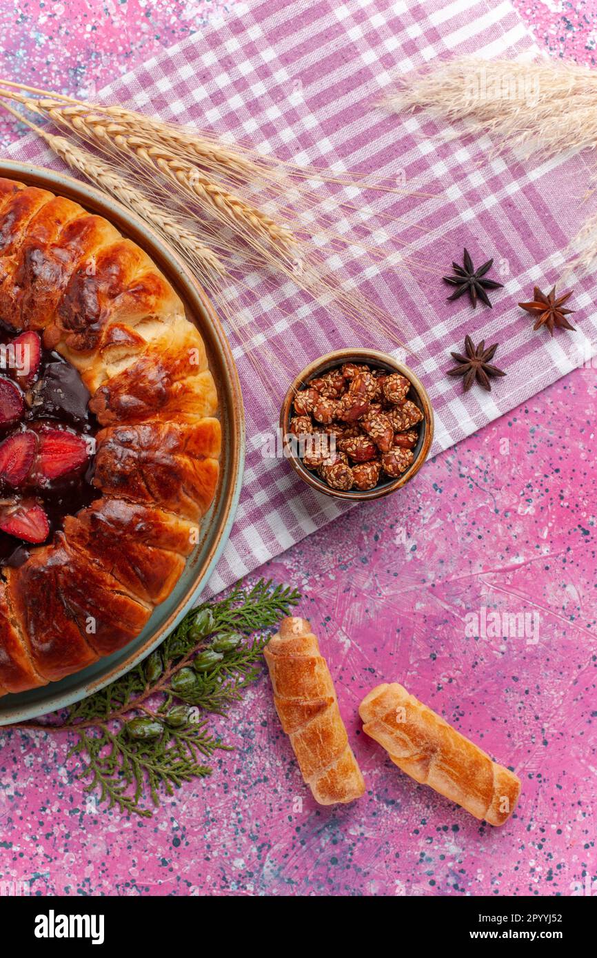 top view yummy strawberry pie fruity cake with bagels on pink ...