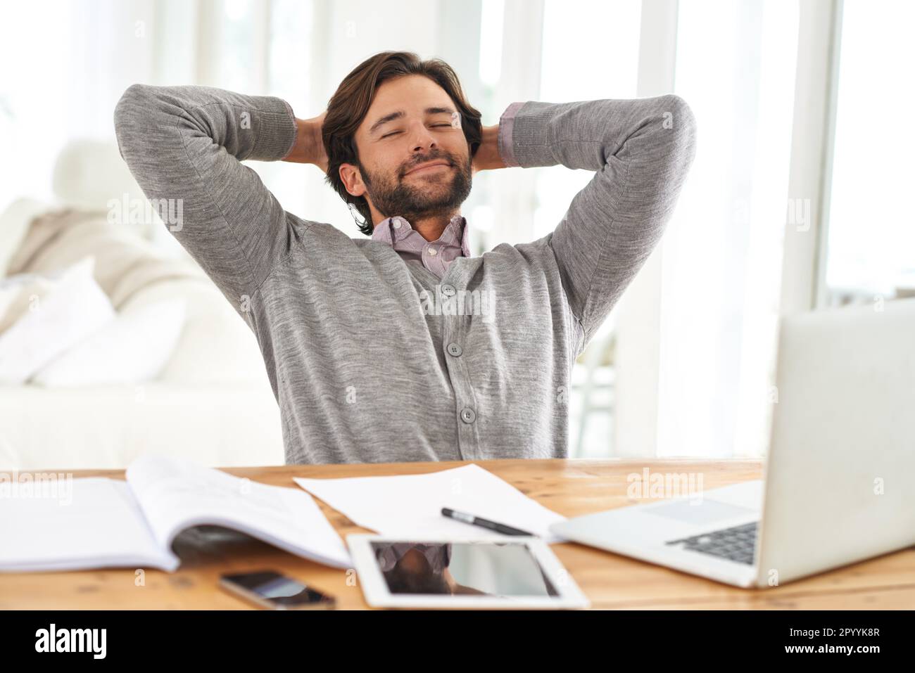Taking time out from the rat race. A handsome businessman relaxing at ...