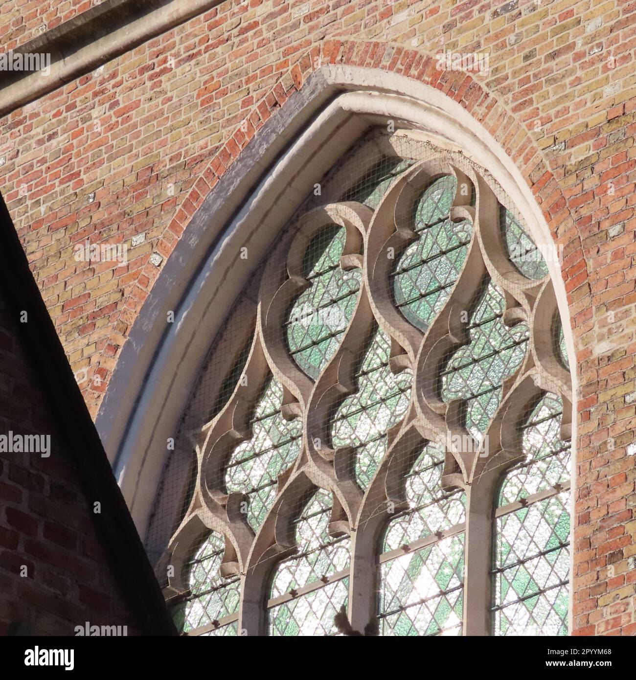 An old brick building with an arched window framed by a detailed ...