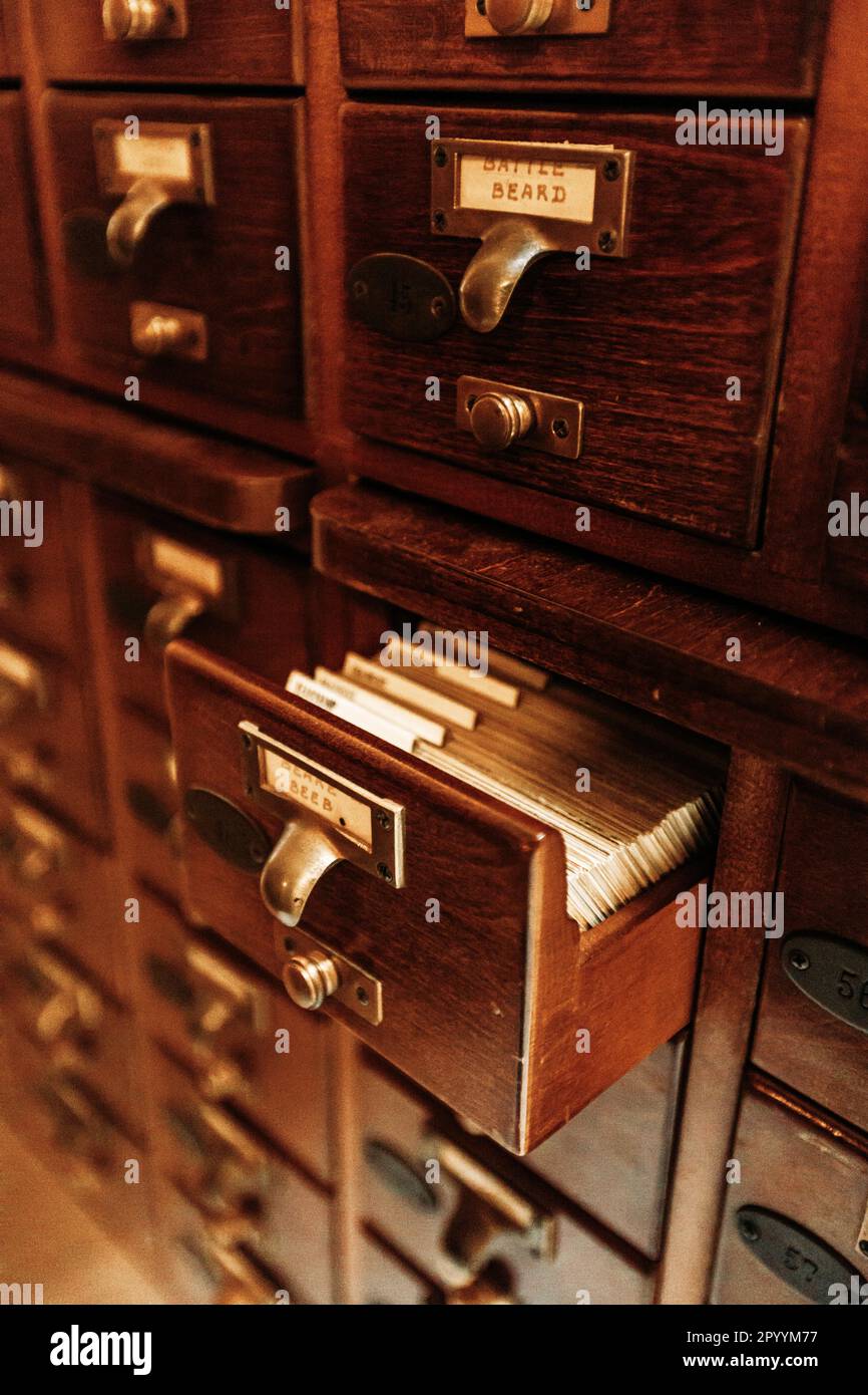 A vintage wooden drawer filled with book note cards in a library Stock ...