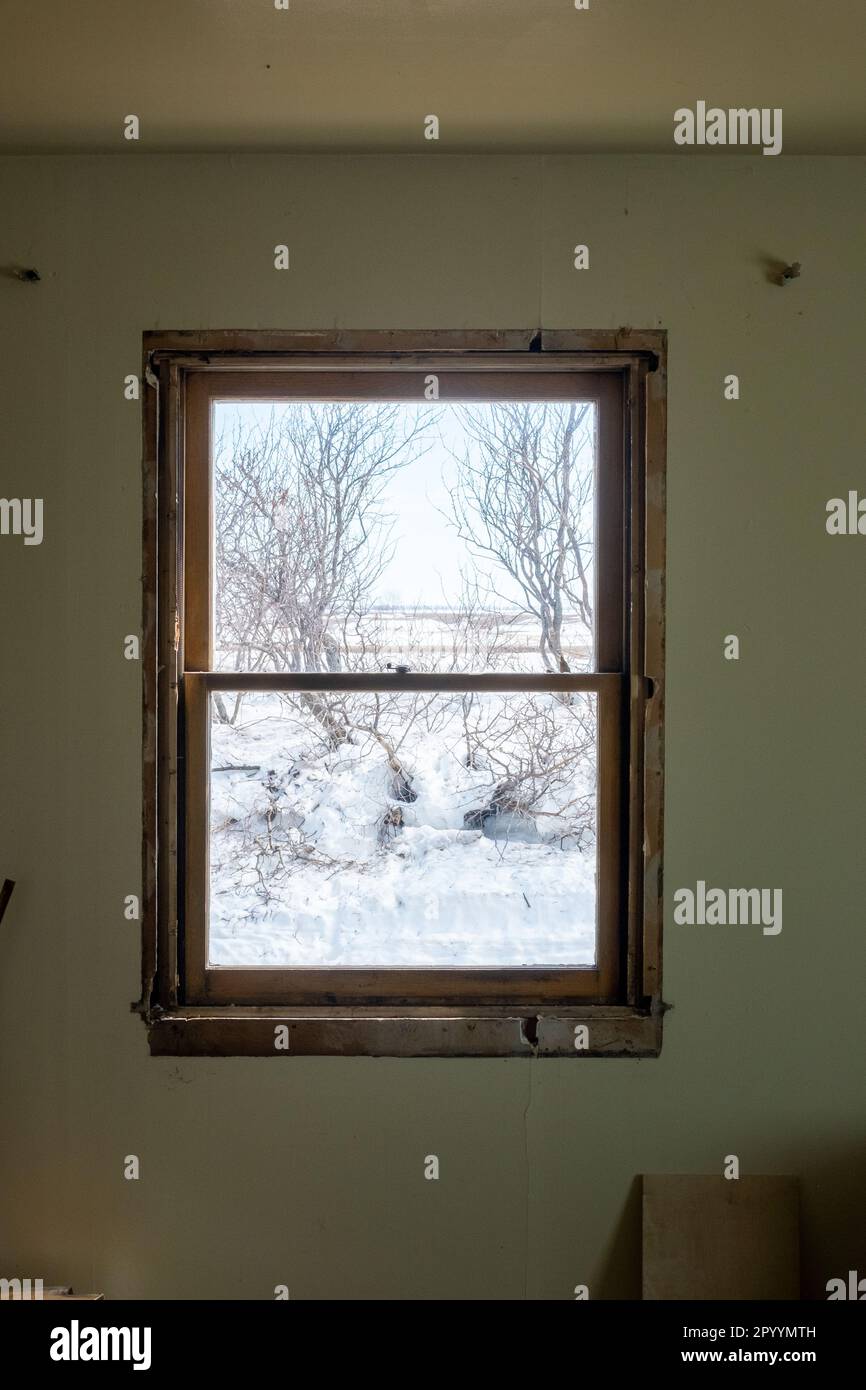 DIY window insert install in old house with wintery snow and trees in ...