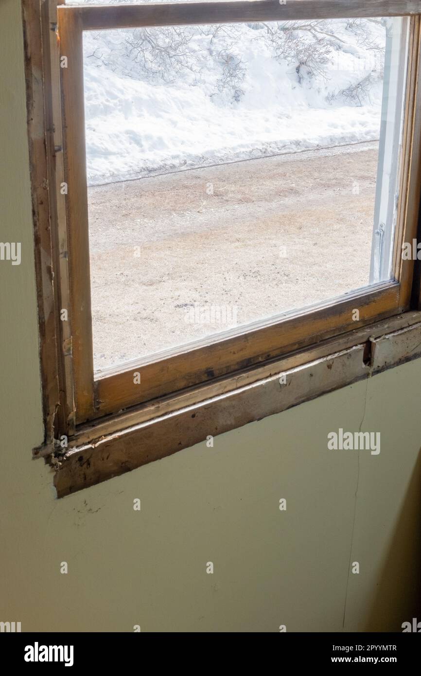DIY window insert install in old house with wintery snow and trees in ...