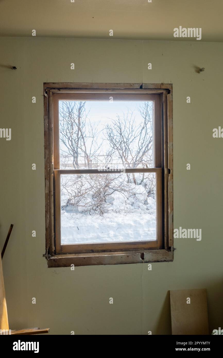 DIY window insert install in old house with wintery snow and trees in ...