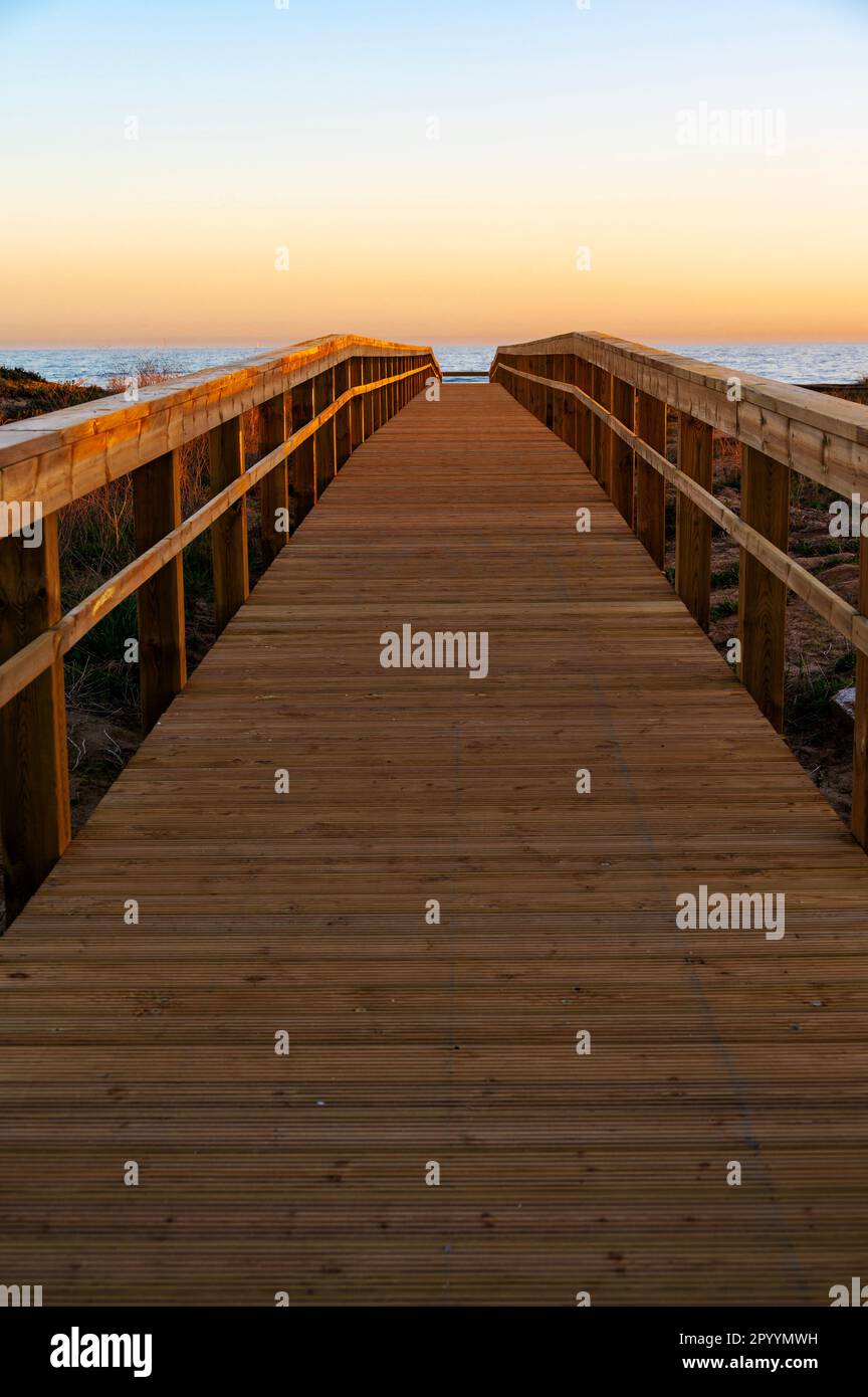 Wooden boardwalk over the beach Stock Photo - Alamy