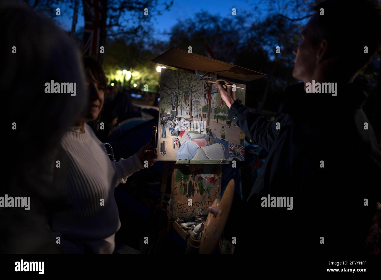 Artist Charles Minty works on an oil painting of royals camping along ...