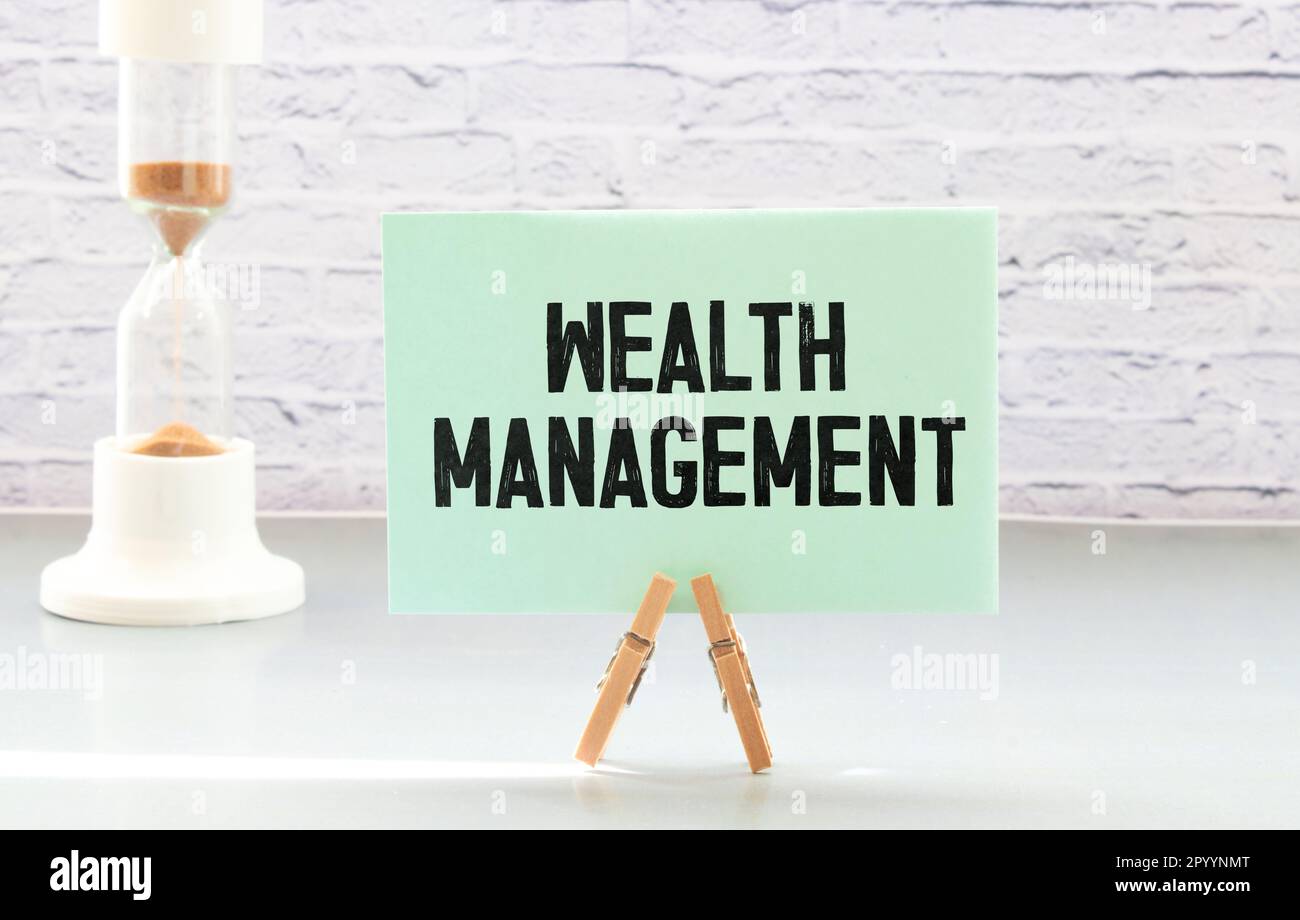 WEALTH MANAGEMENT written on a paper with office tools and keyboard on ...