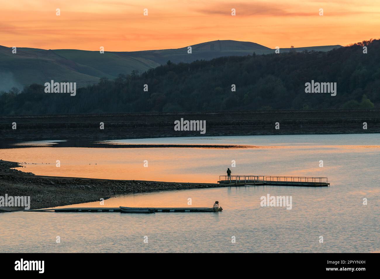 Fishermen catching a fish at Ladybower Reservoir at Manchester, UK ...