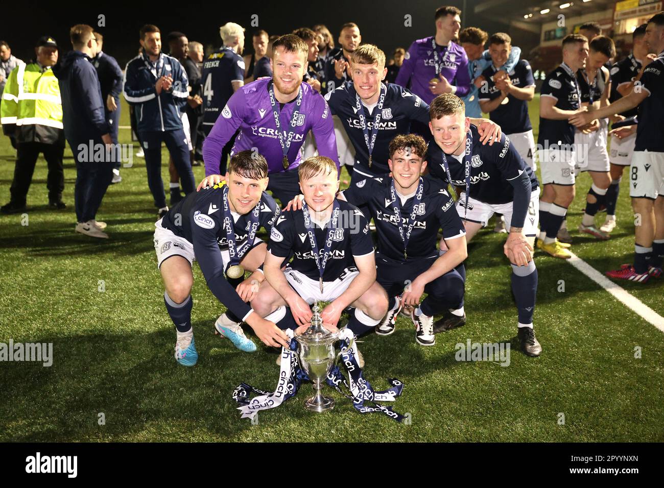 Dundee's Lyall Cameron (bottom centre) celebrates with the trophy and ...