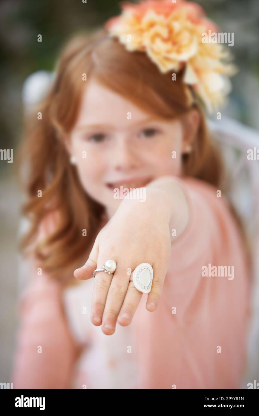 Little lady. A girl playing dress up showing her costume rings Stock ...