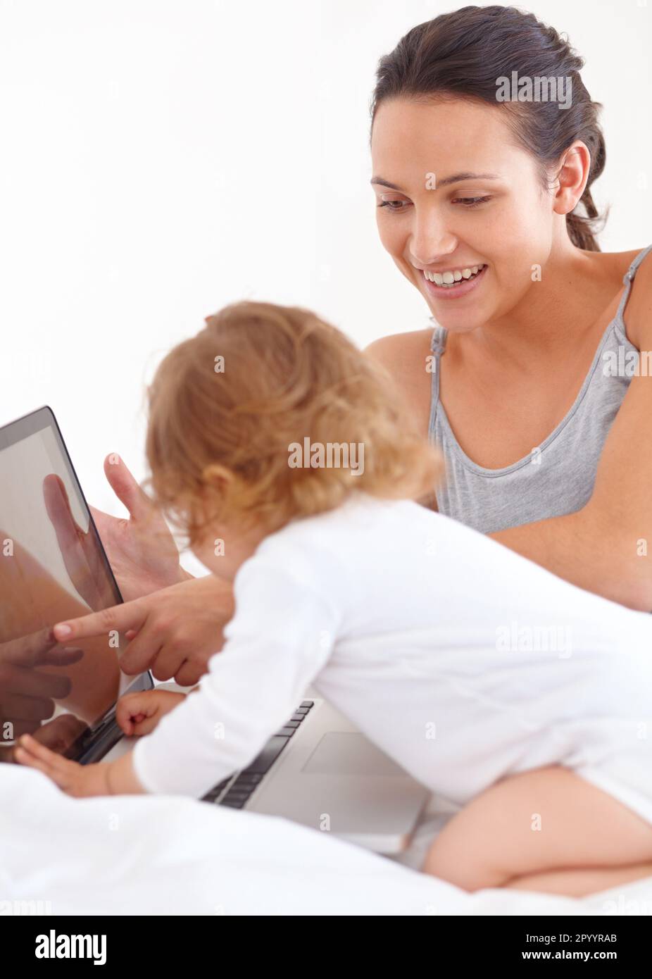 Growing up in a world of technology. A young mother showing her baby ...