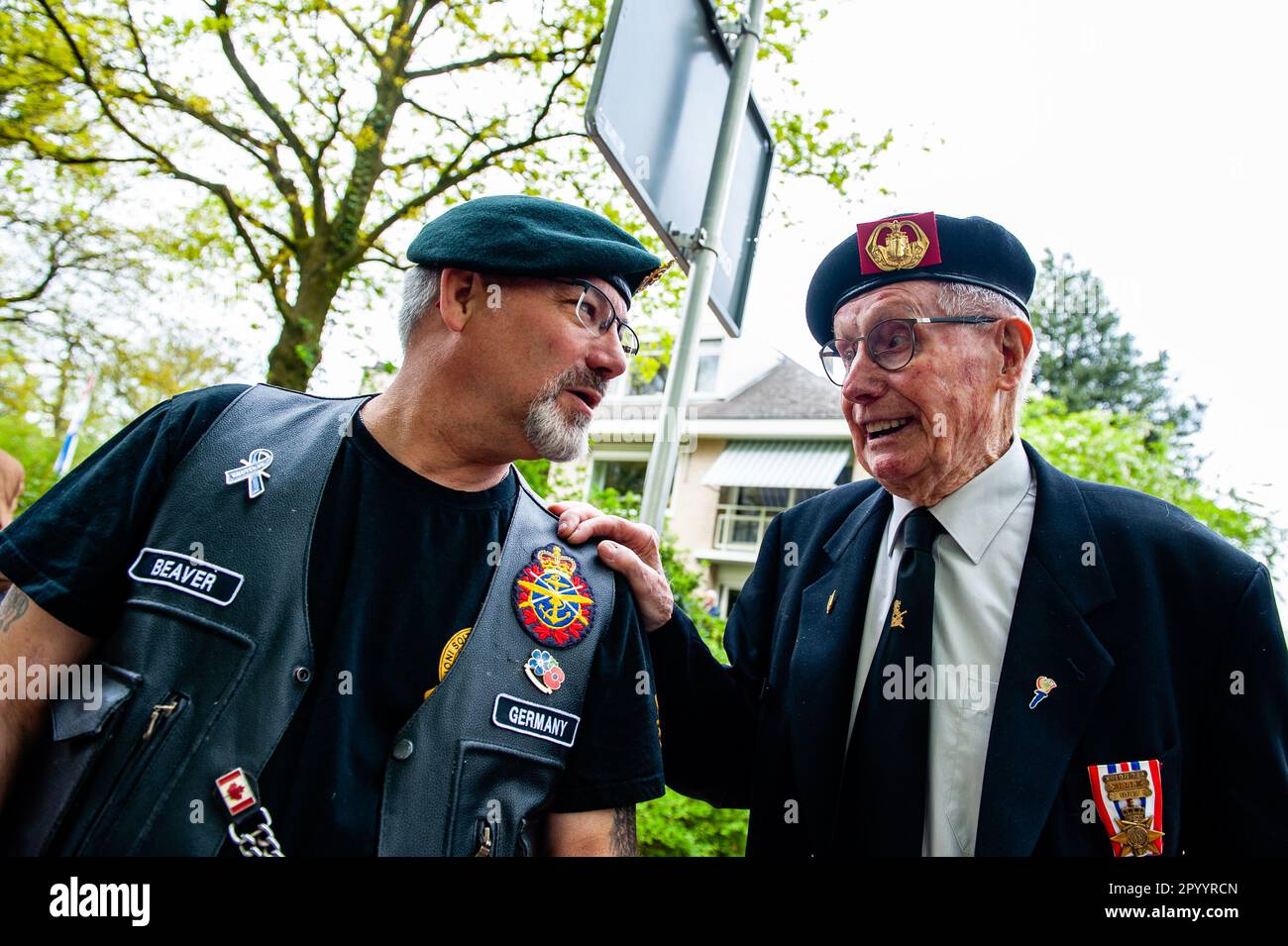 Two war veterans are seen talking to each other during the Liberation ...
