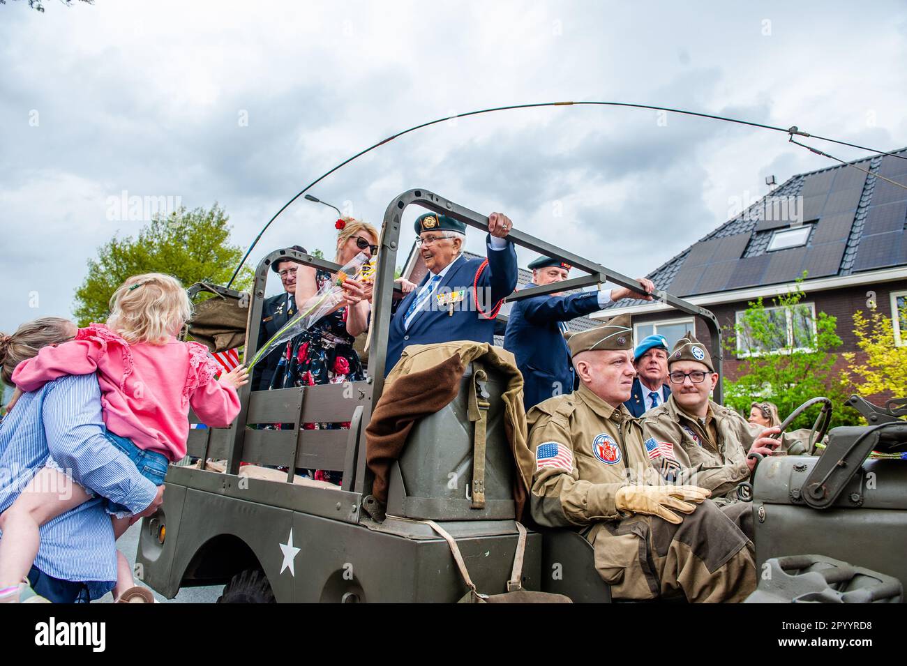 A little girl is seen giving a flower to one of the war veterans during ...