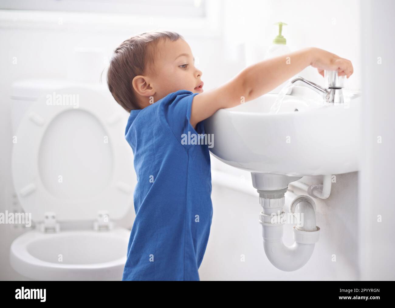 Hygienic habits. a cute young boy washing his hands in a bathroom Stock ...