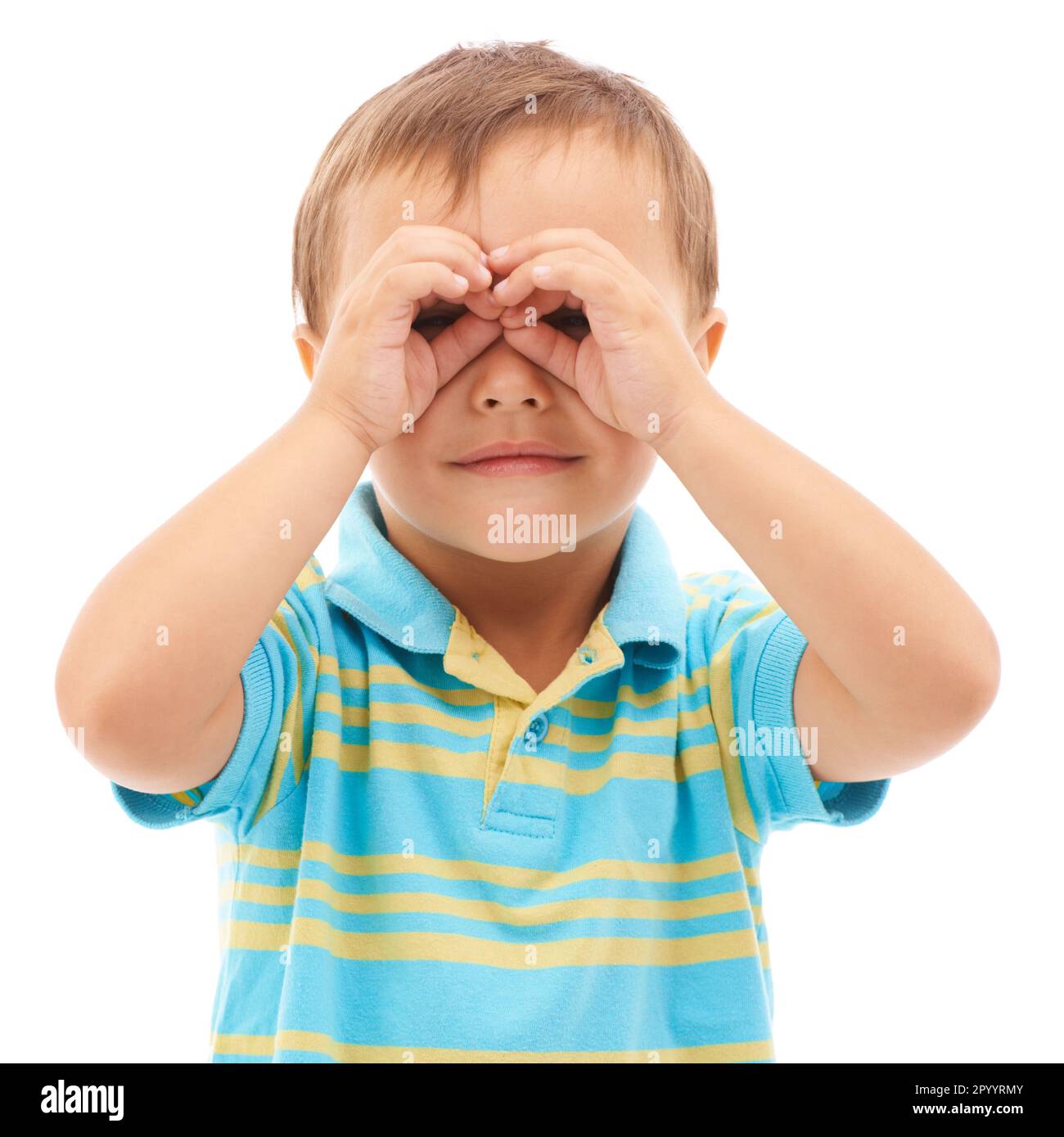 I can see you. Studio shoot of a cute young boy peeking at the camera ...
