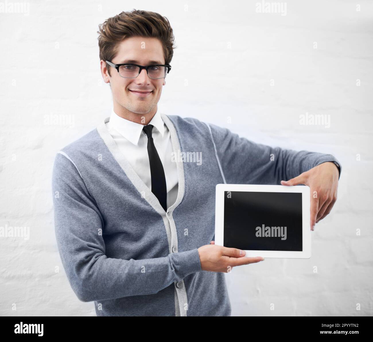 Put your text in his capable hands. A nerdy guy holding a digital tablet Stock Photo - Alamy