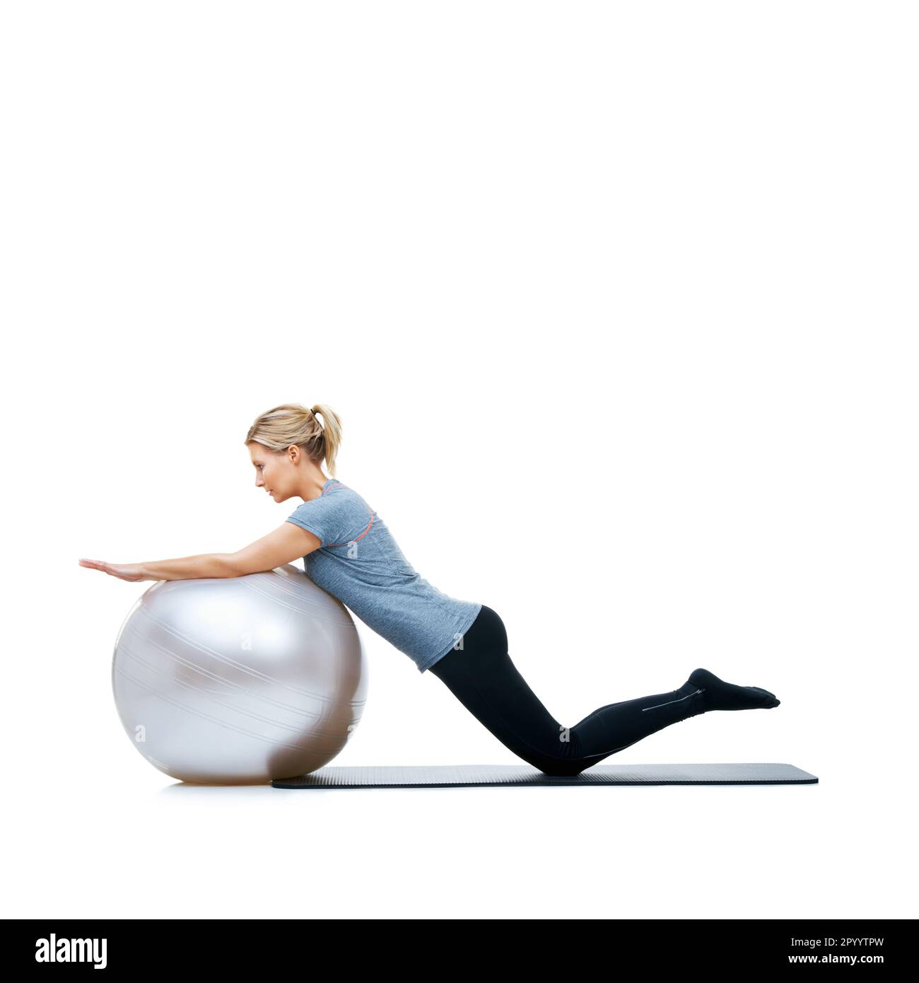 Working on my balance. a female balancing on an exercise ball with a ...