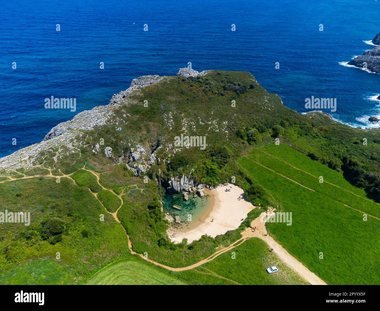 Aerial view on small Playa de Gulpiyuri, flooded sinkhole with inland ...