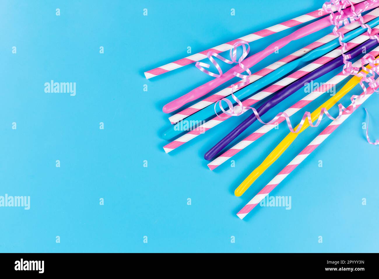 a top view colorful straws long sticky isolated on the blue background ...