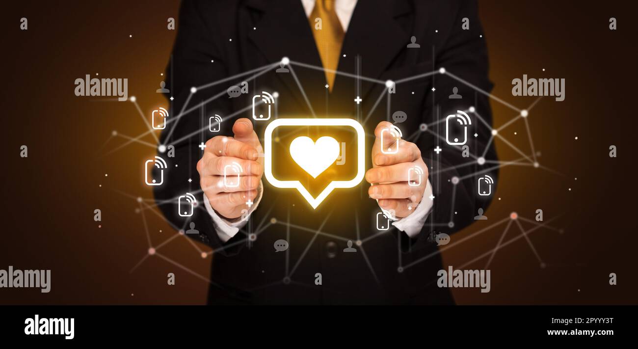 Hand holding social media icons Stock Photo - Alamy