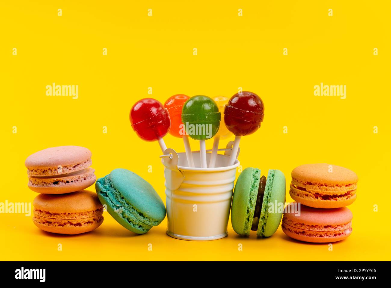 a top view french macarons along with lollipops and colorful candies ...