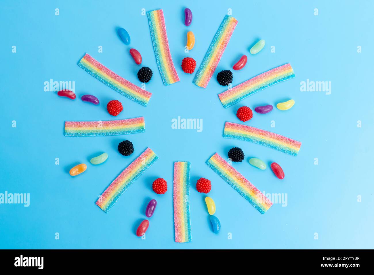 a top view marmalades and candies colorful on the blue desk candy sweet ...