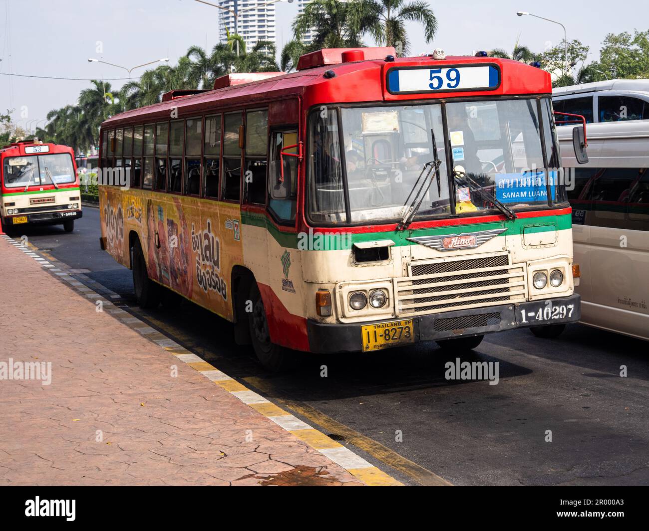 Amongst Bangkok's busy streets, a colorful old bus stands out with its ...