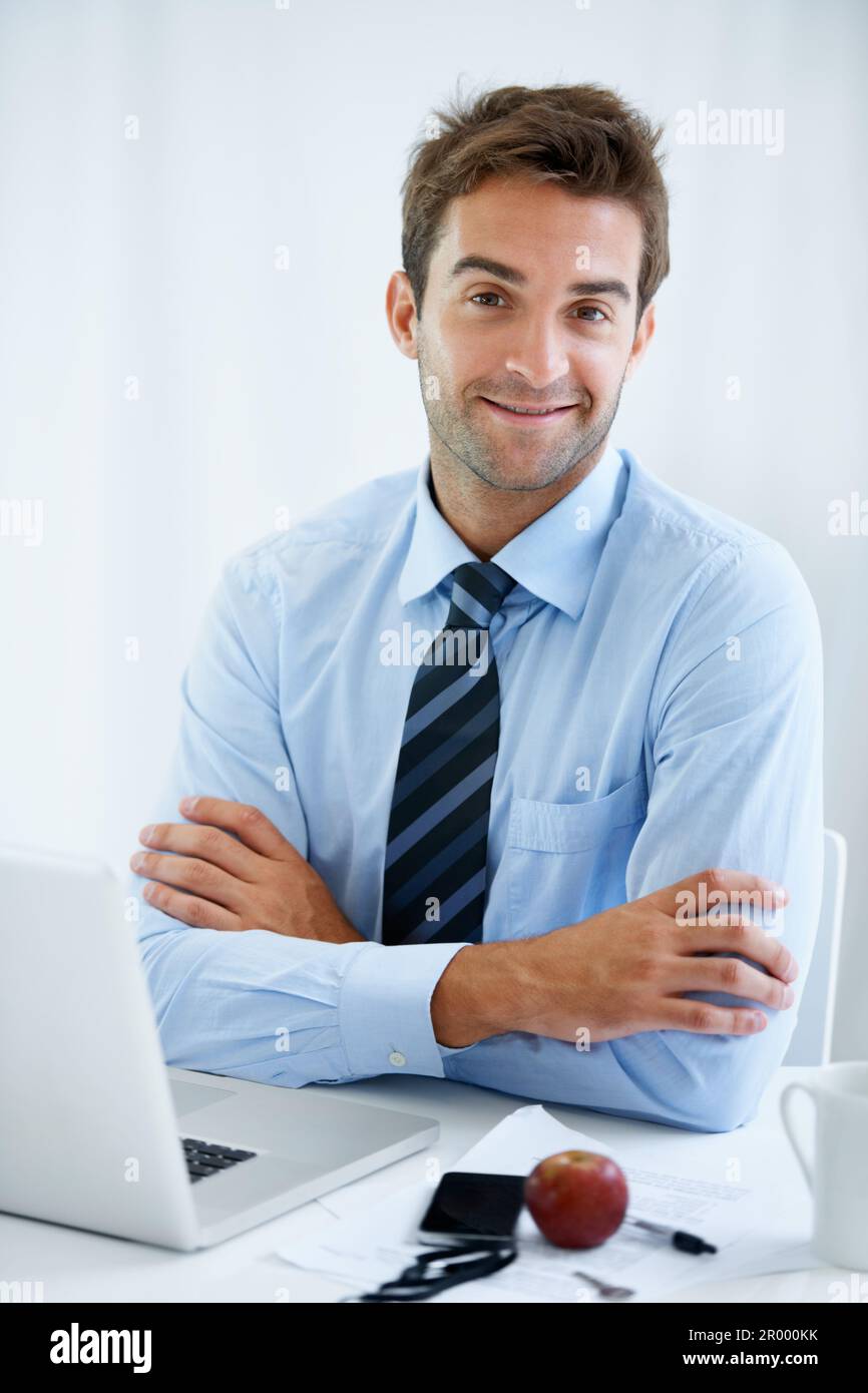 The modern professional. a handsome young businessman at work Stock ...