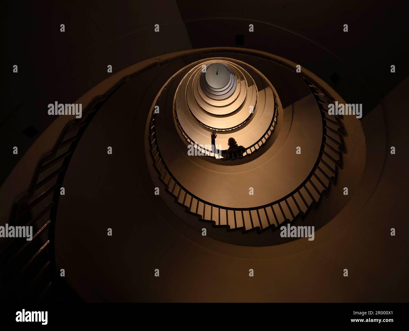 Spiral staircase in a tall multi-floor house, in the form of a "golden ...