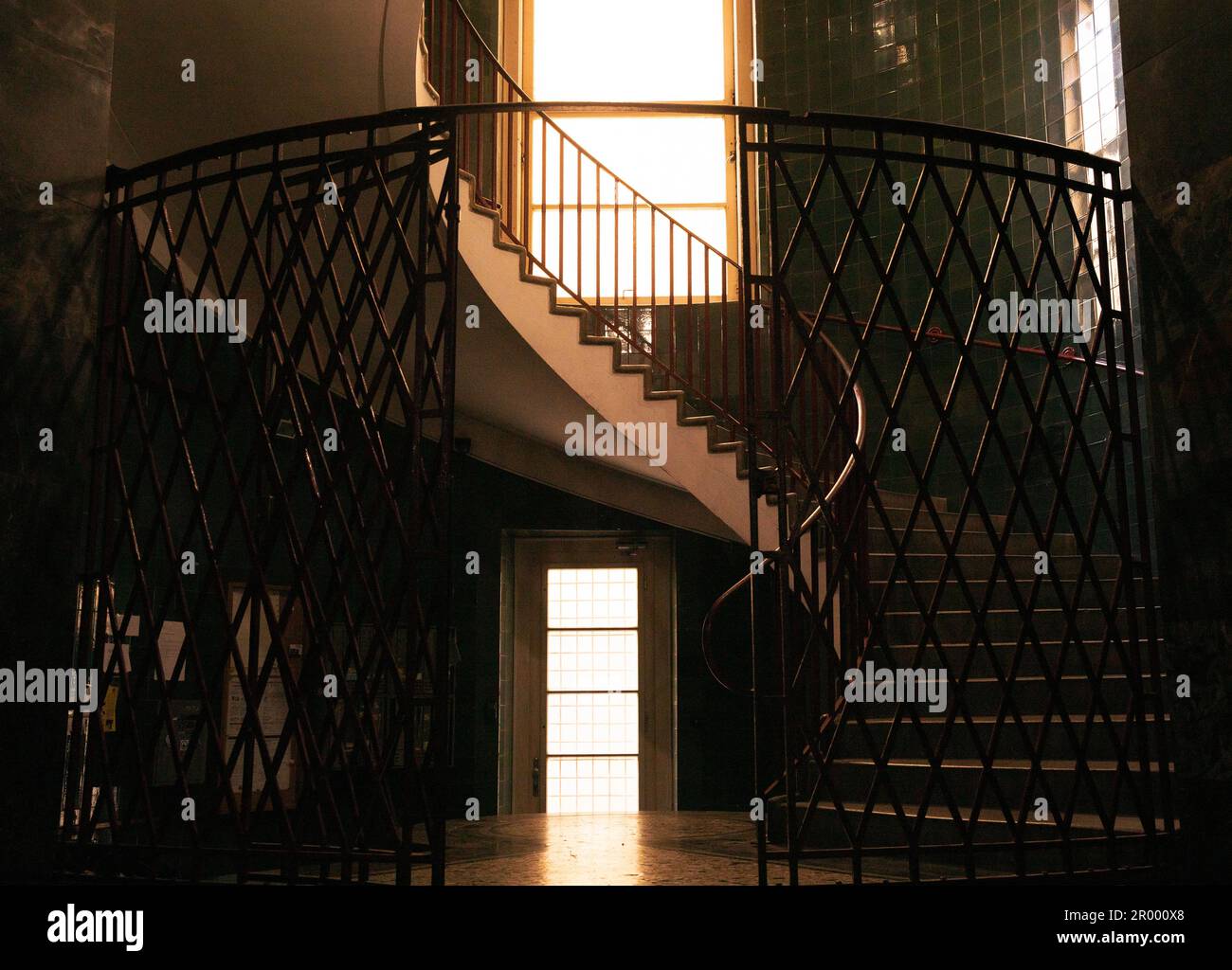 Spiral staircase in a tall multi-floor house, in the form of a "golden ...