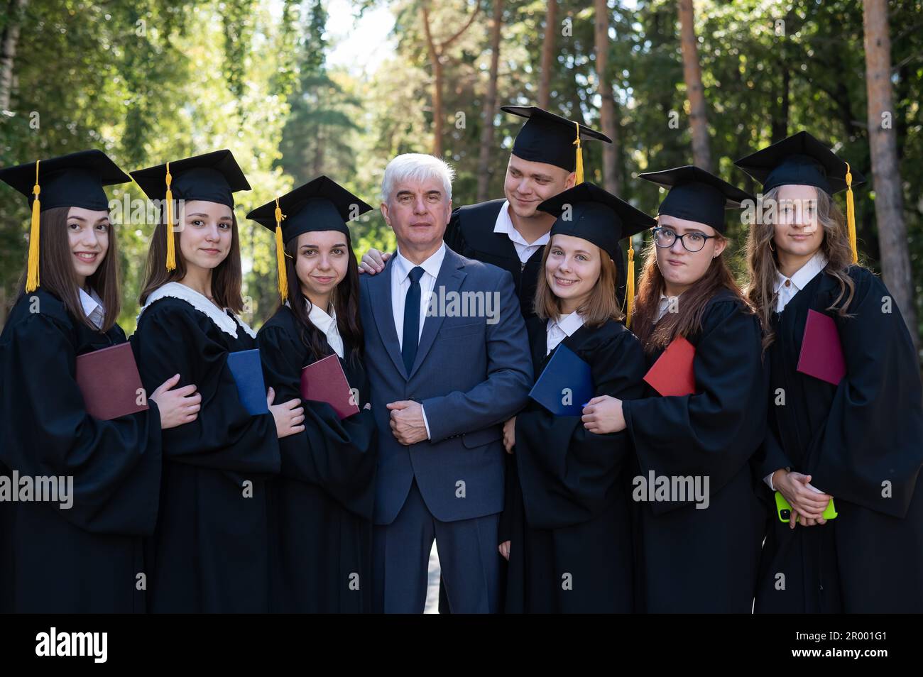 University professor and seven graduates rejoice at graduation Stock ...