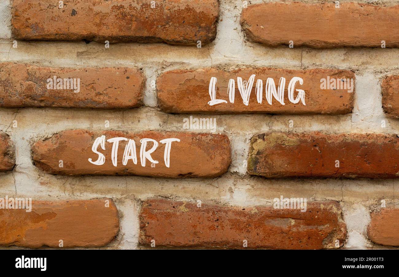 Start living symbol. Concept words Start living on beautiful red brown ...