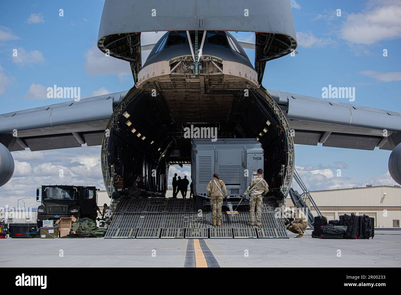 U.S. Air Force Airmen load cargo onto a C-5 Galaxy, assigned to Travis ...