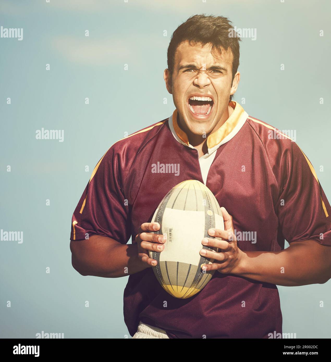 Driven by passion. Cropped portrait of a young rugby player shouting ...