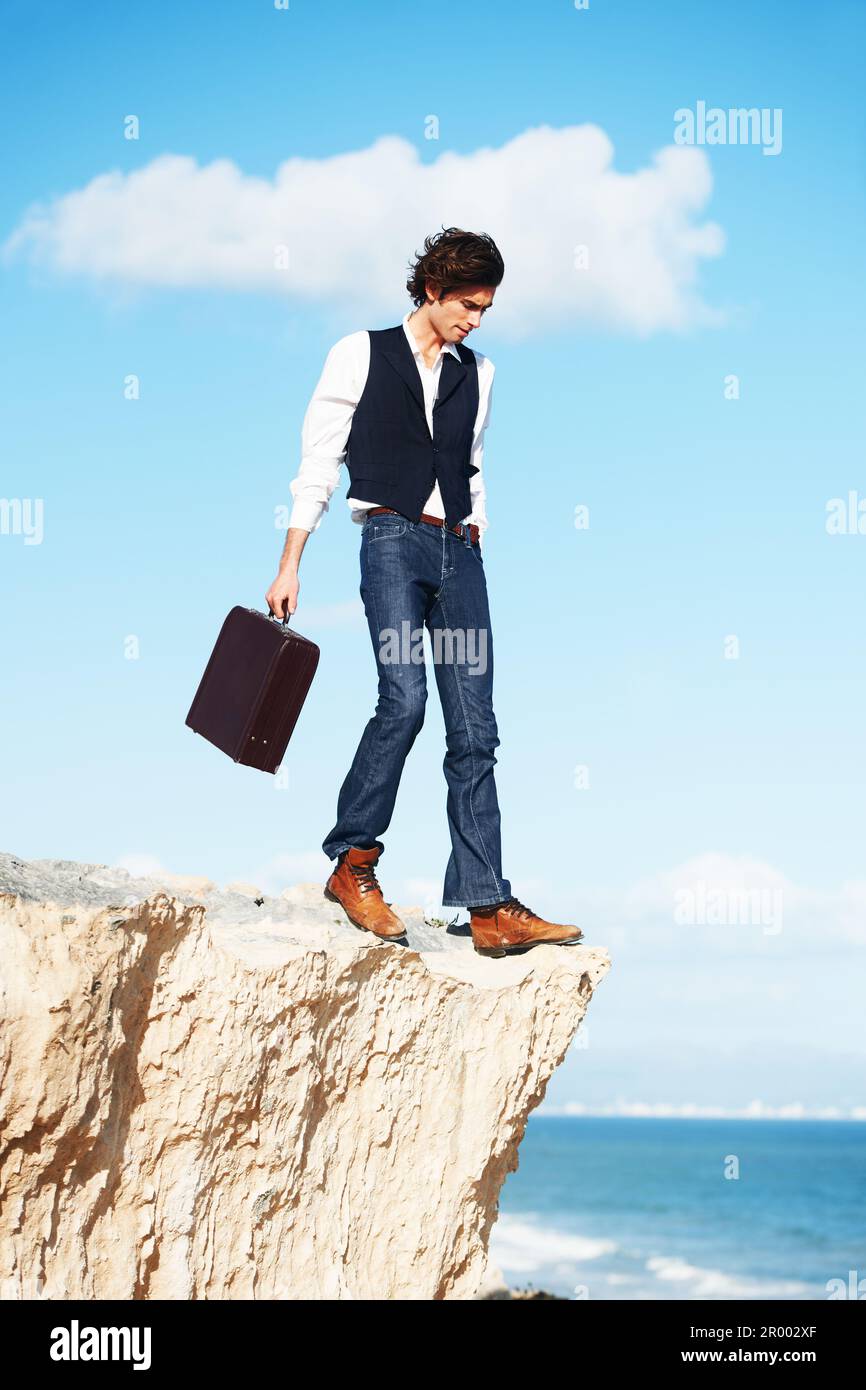 Living on the edge. Young semi-formal businessman stepping towards the ...