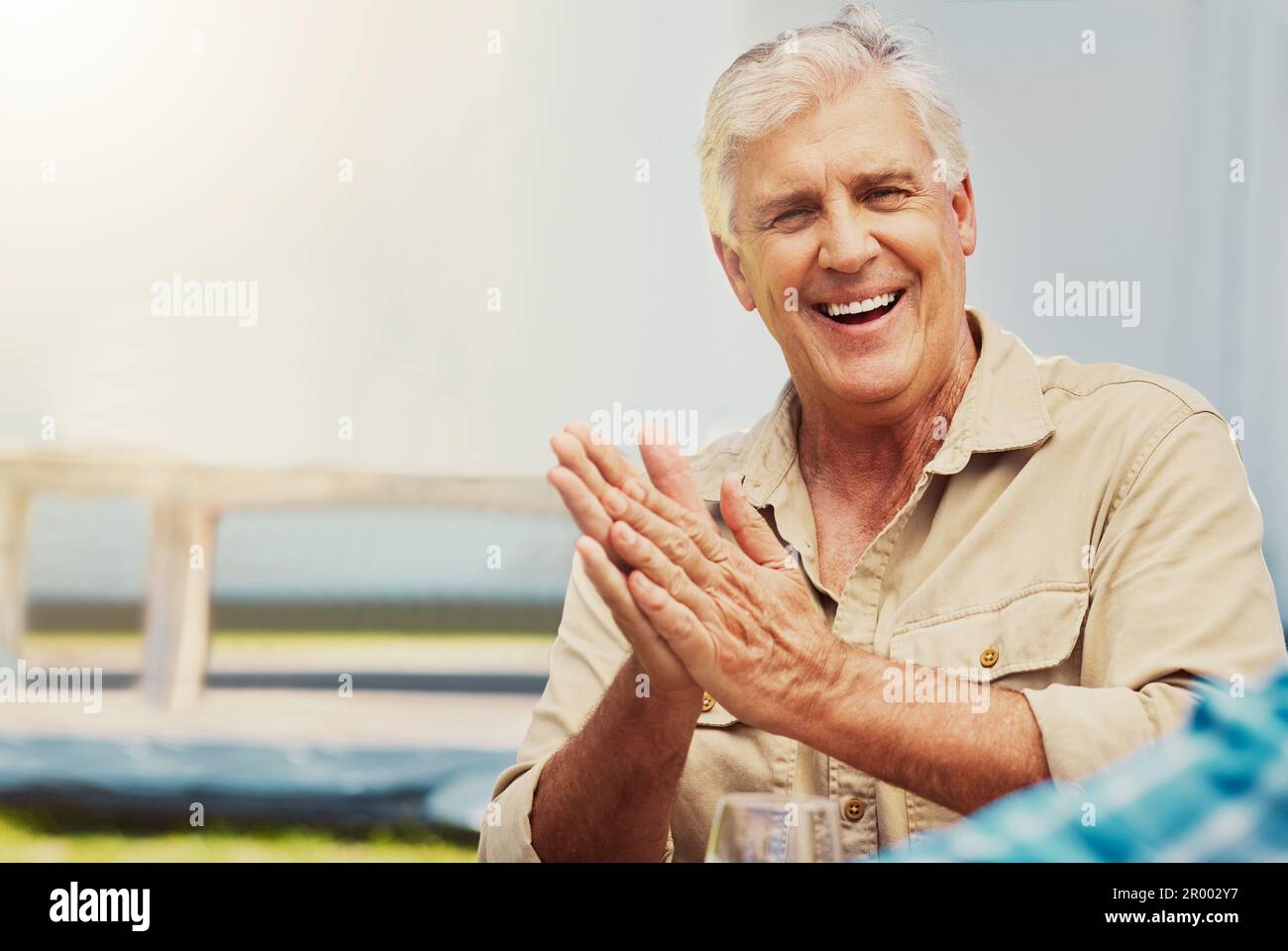 One smiling senior caucasian man clapping while enjoying wine tasting ...