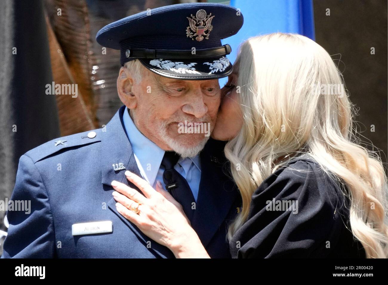 U.S. Air Force Col. Buzz Aldrin, retired, left, gets a kiss from his ...