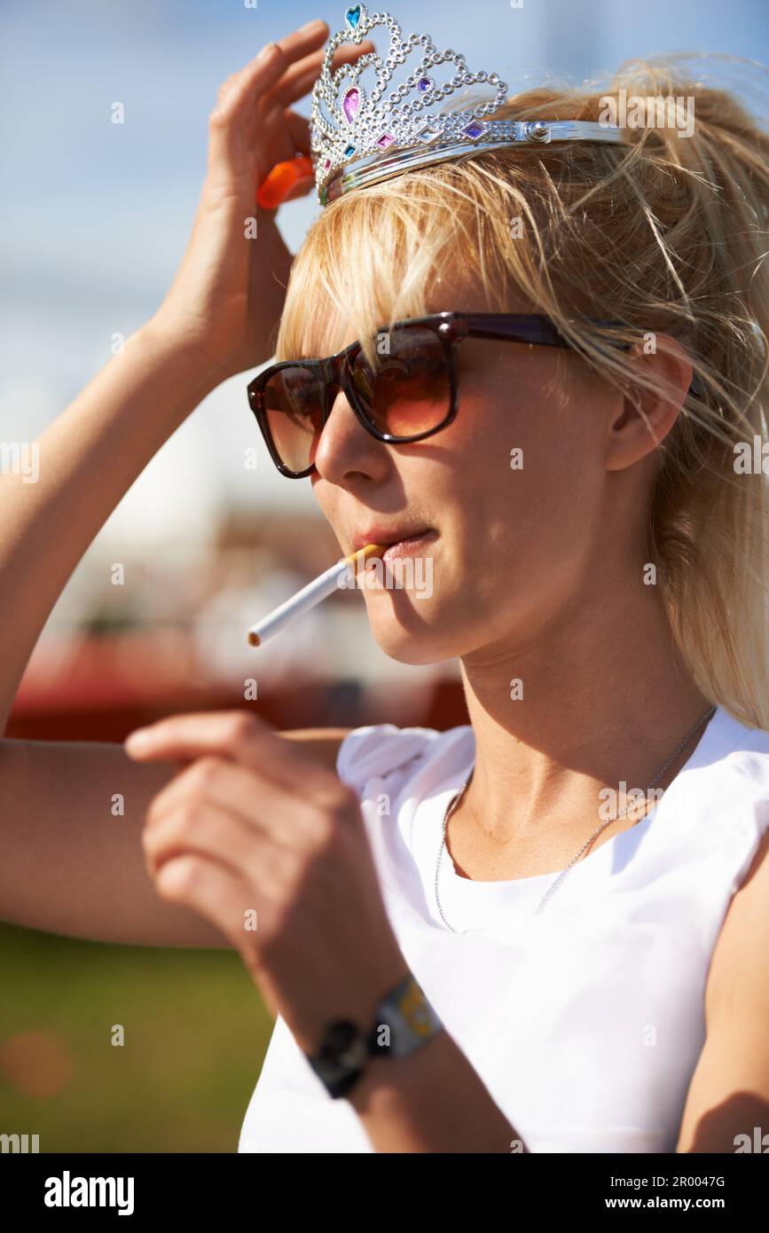 Puffing princess. a young woman smoking a cigarette Stock Photo - Alamy